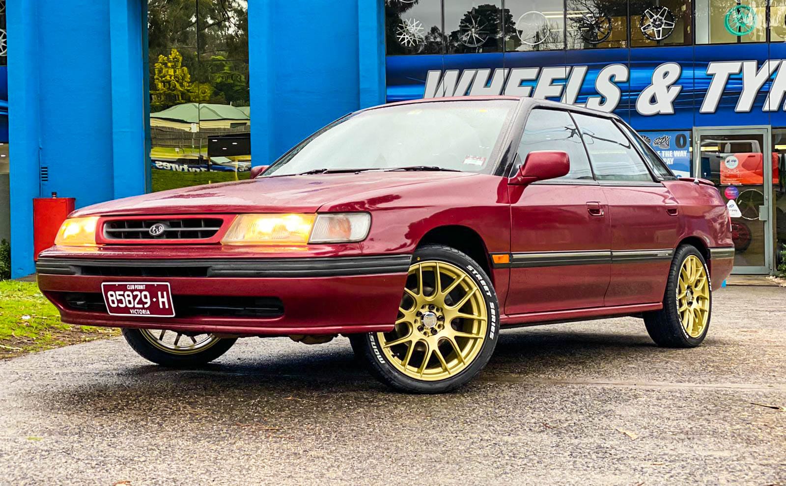 Maroon Subaru Legacy Wheels Gold